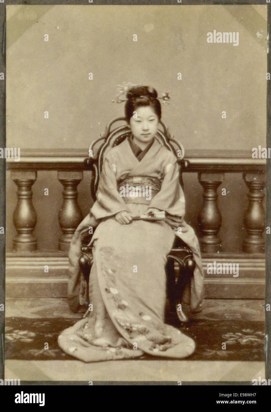 Photograph of a woman sitting in a traditional Japanese chair ...