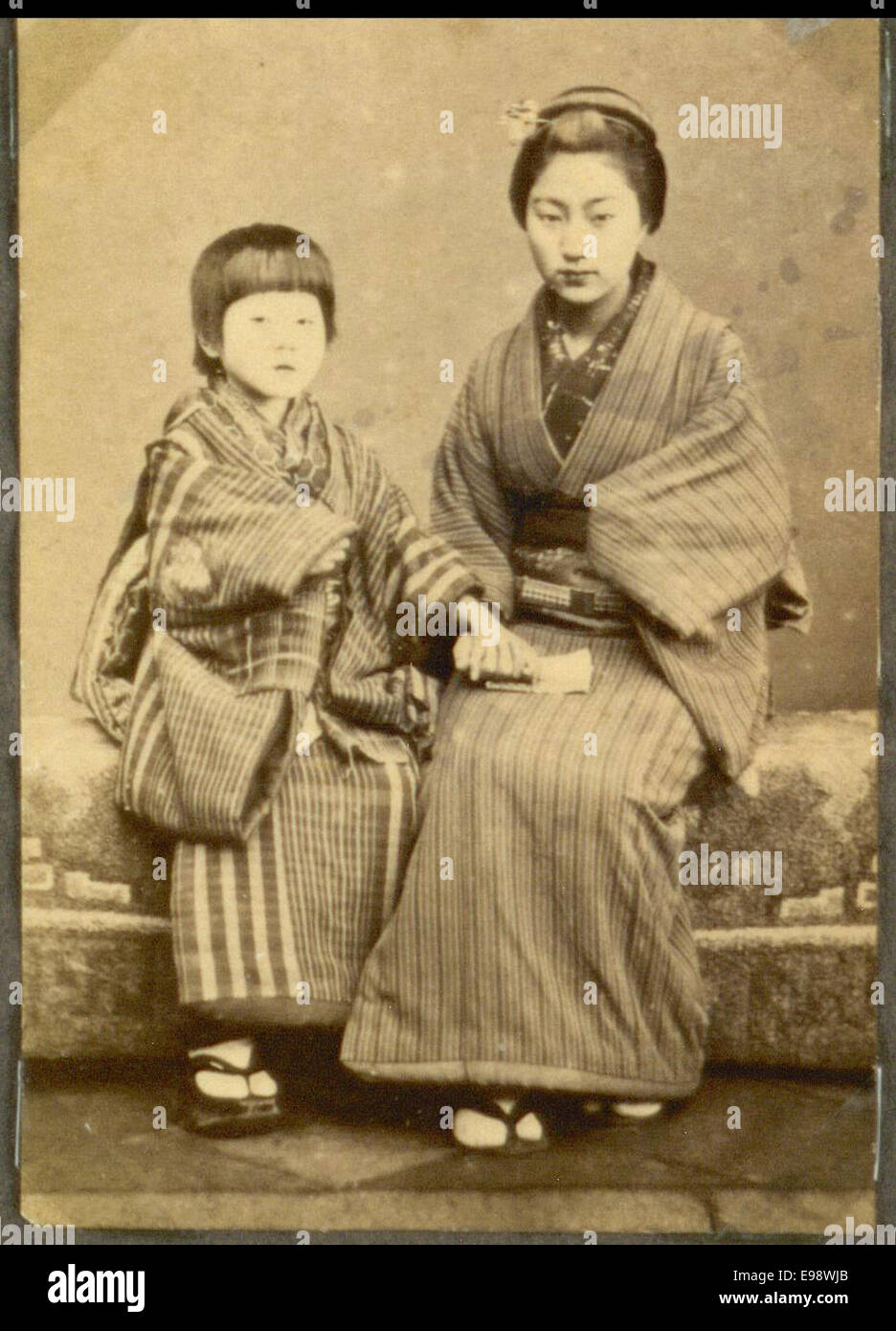 A vintage photograph depicting a Japanese woman and child, possibly ...