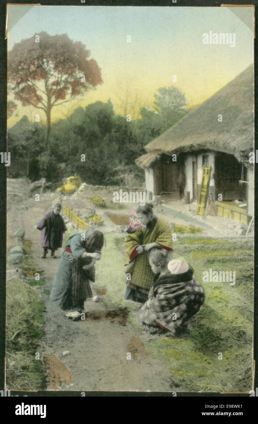 This photograph shows a woman and children in a traditional Japanese ...