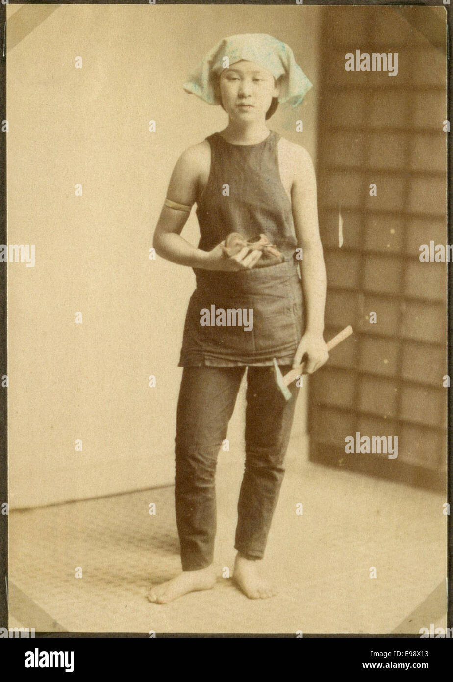 This photograph features a woman worker in Japan, likely from the early ...