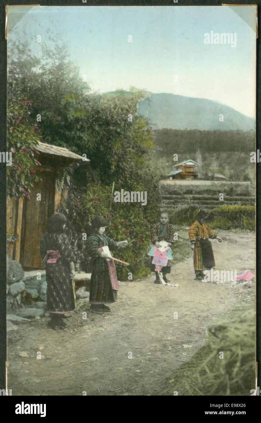 This image captures children playing in Japan, with one child holding a ...