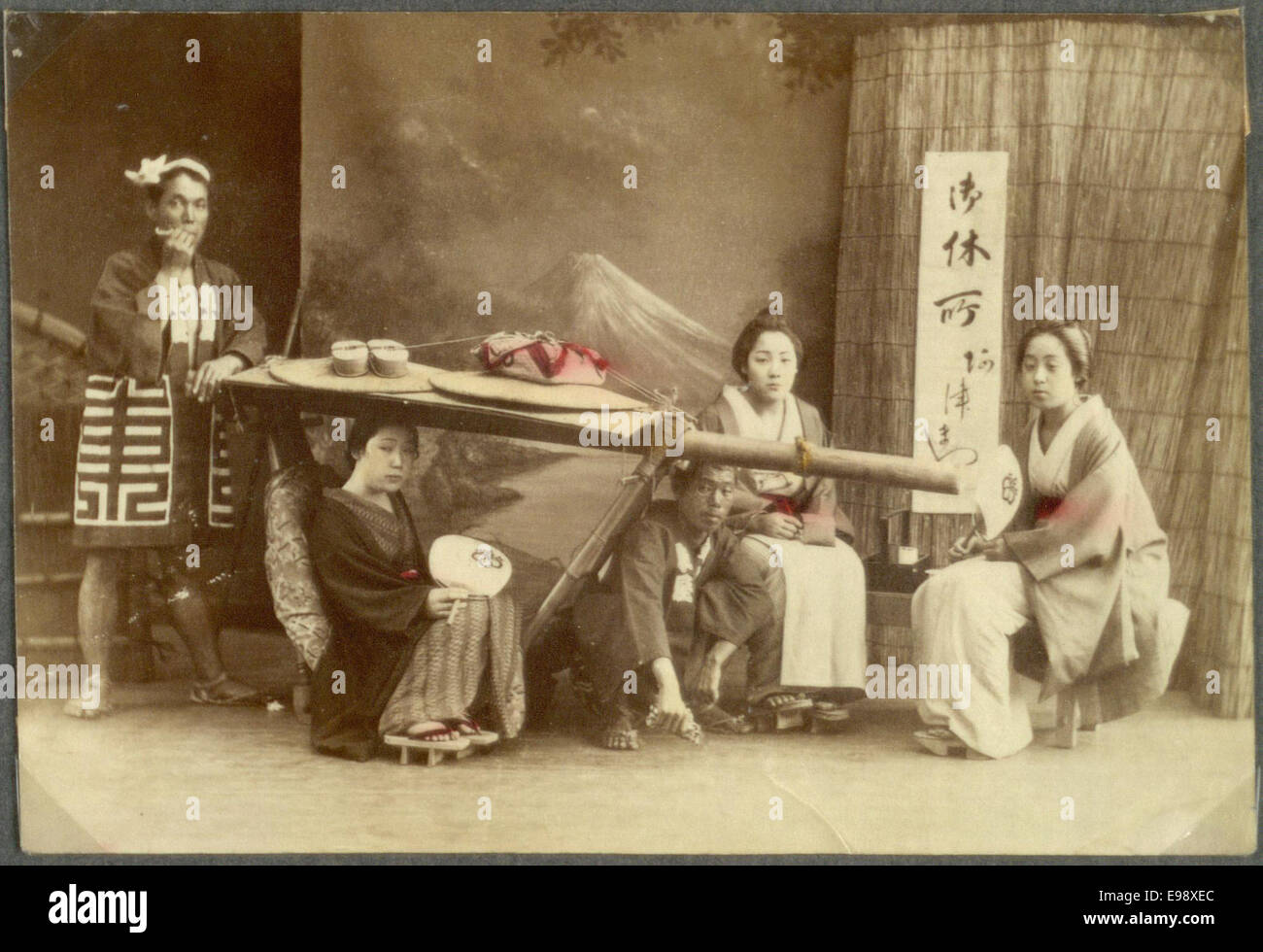 A historical photograph showing a Japanese woman being carried in a ...
