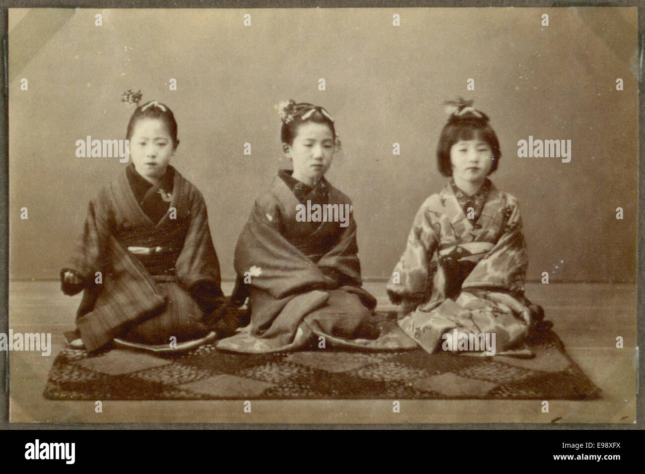 This photograph shows three young girls dressed as geishas in Japan ...