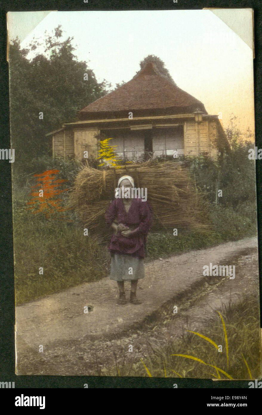 A photograph of a woman carrying bundles on her back, taken in Japan ...