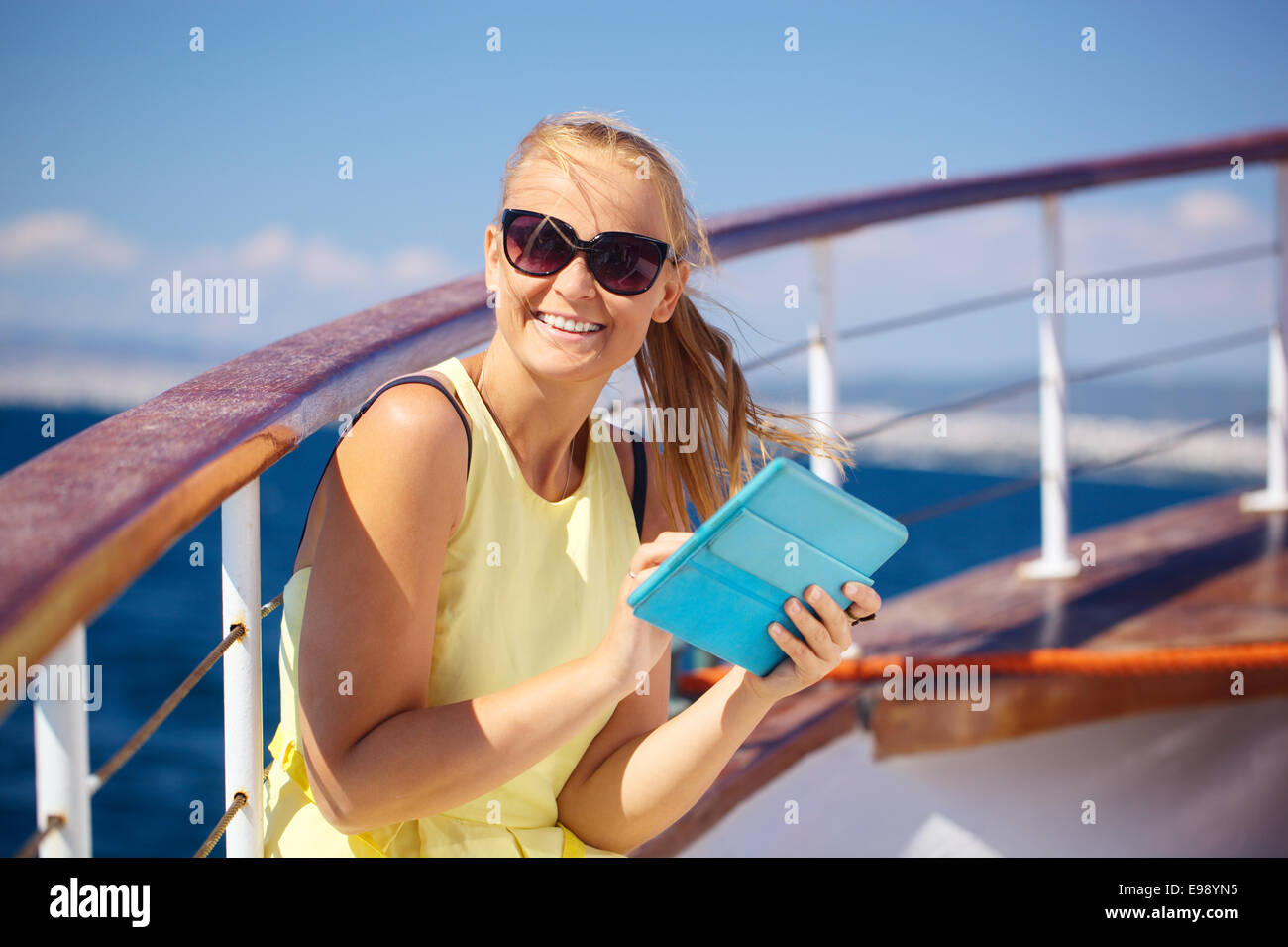 Happy woman with pad during sea traveling Stock Photo - Alamy