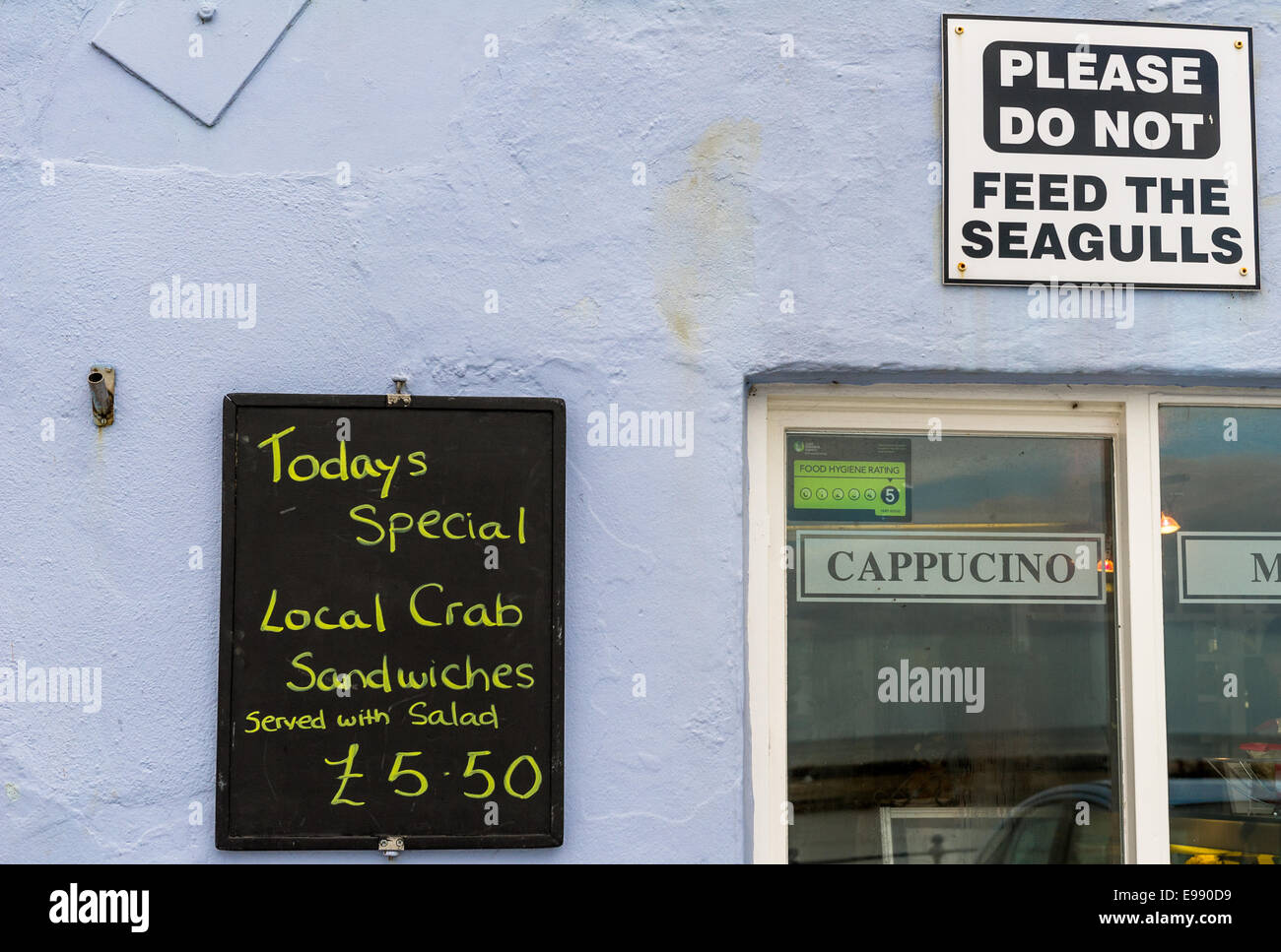 Signs outside a cafe advertising fresh crab sandwiches and do not feed ...