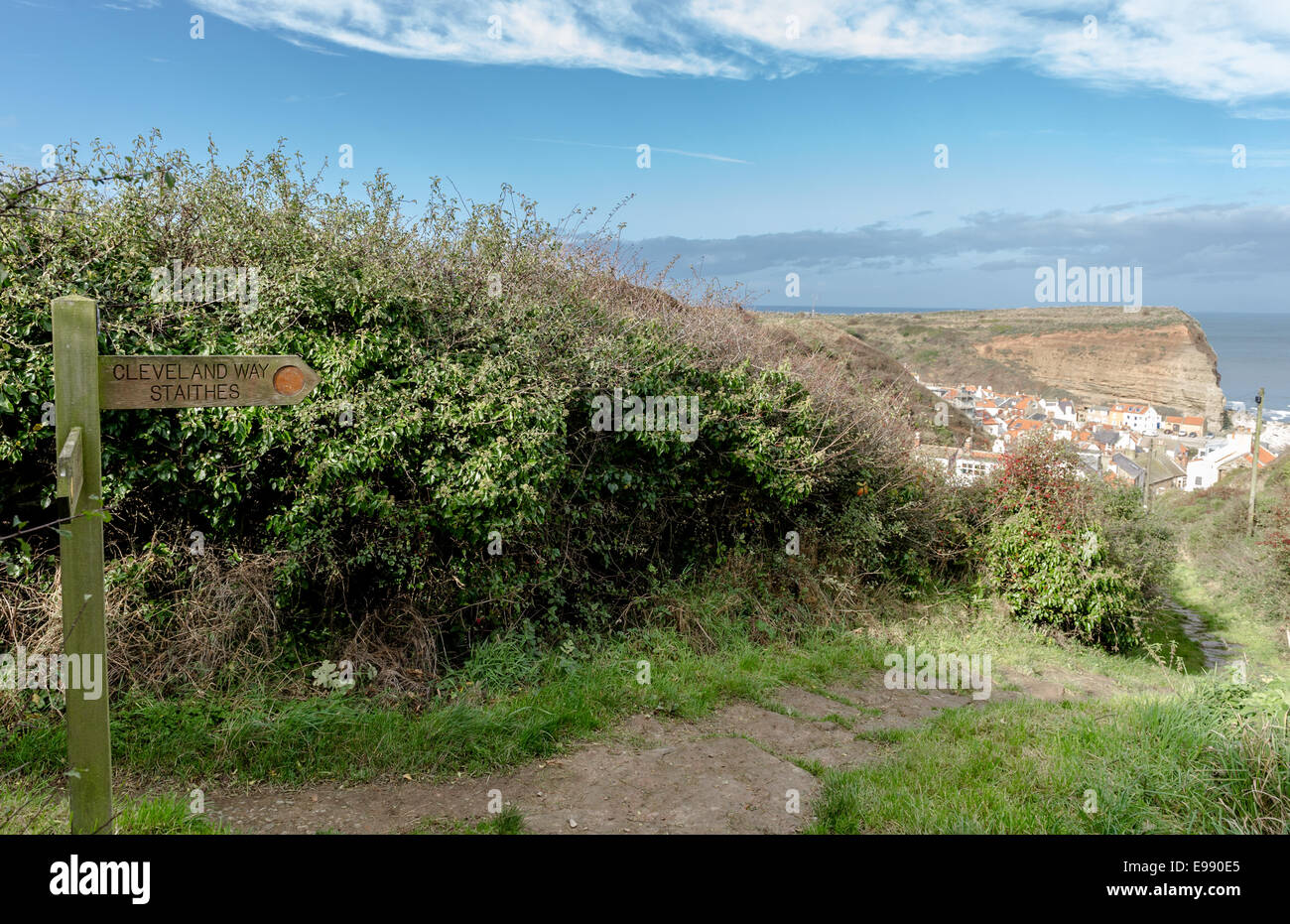 Wooden sign post on the Cleveland way footpath pointing to Staithes a ...