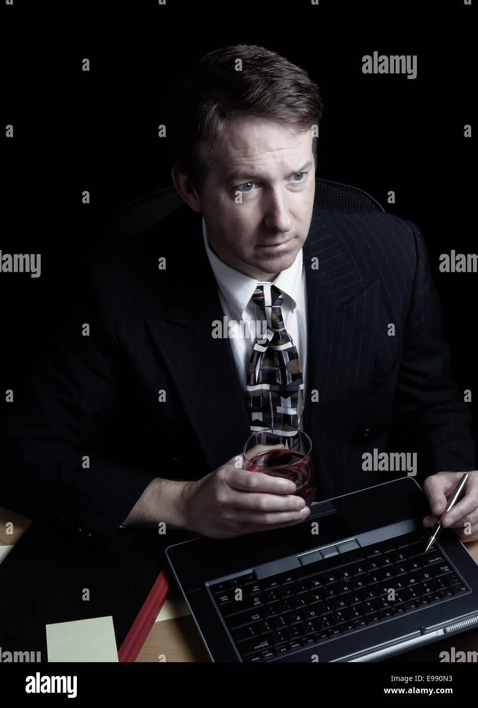 Vertical image of business man, looking at computer screen, working ...