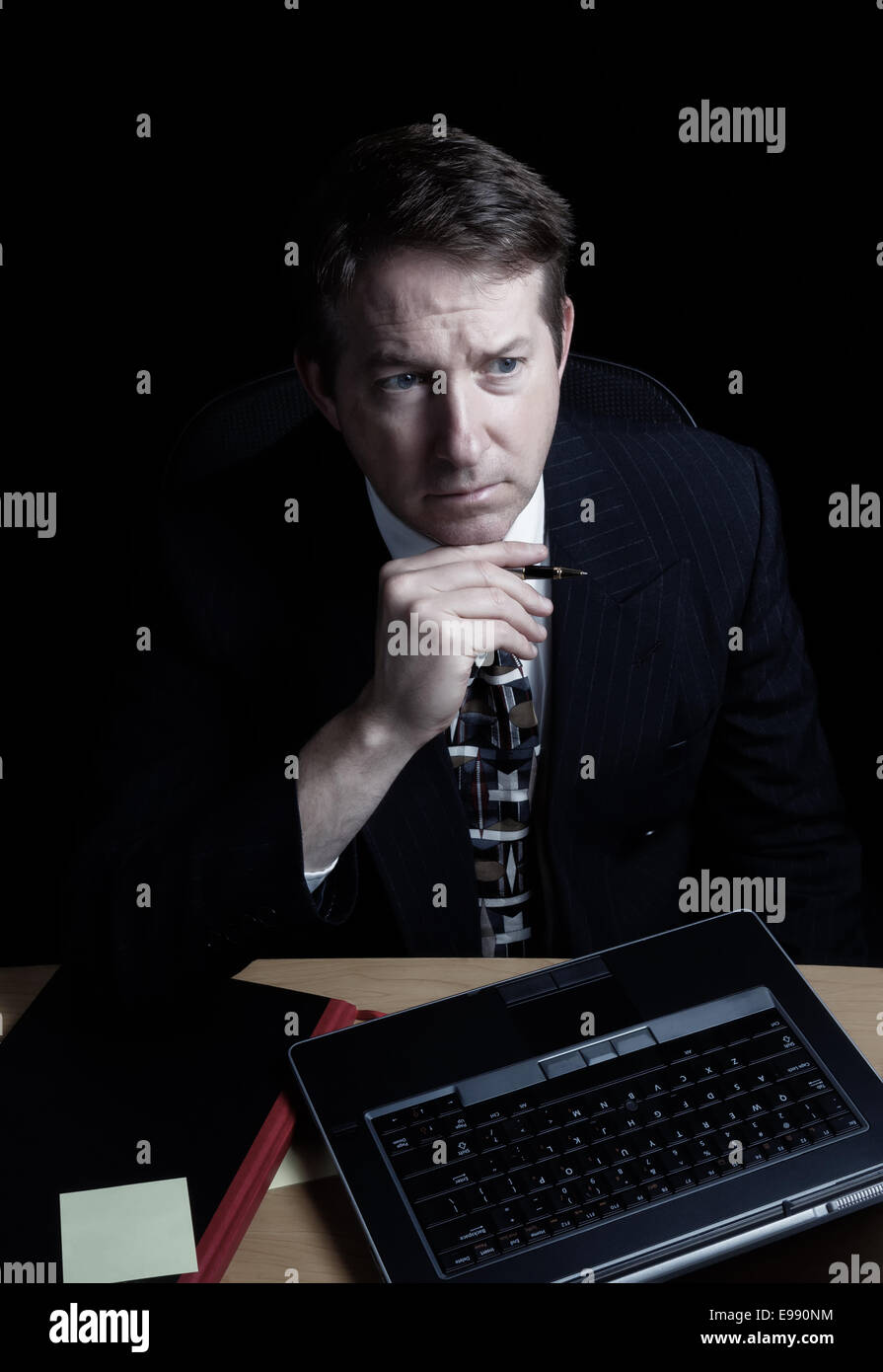 Vertical image of business man, looking at computer screen while ...