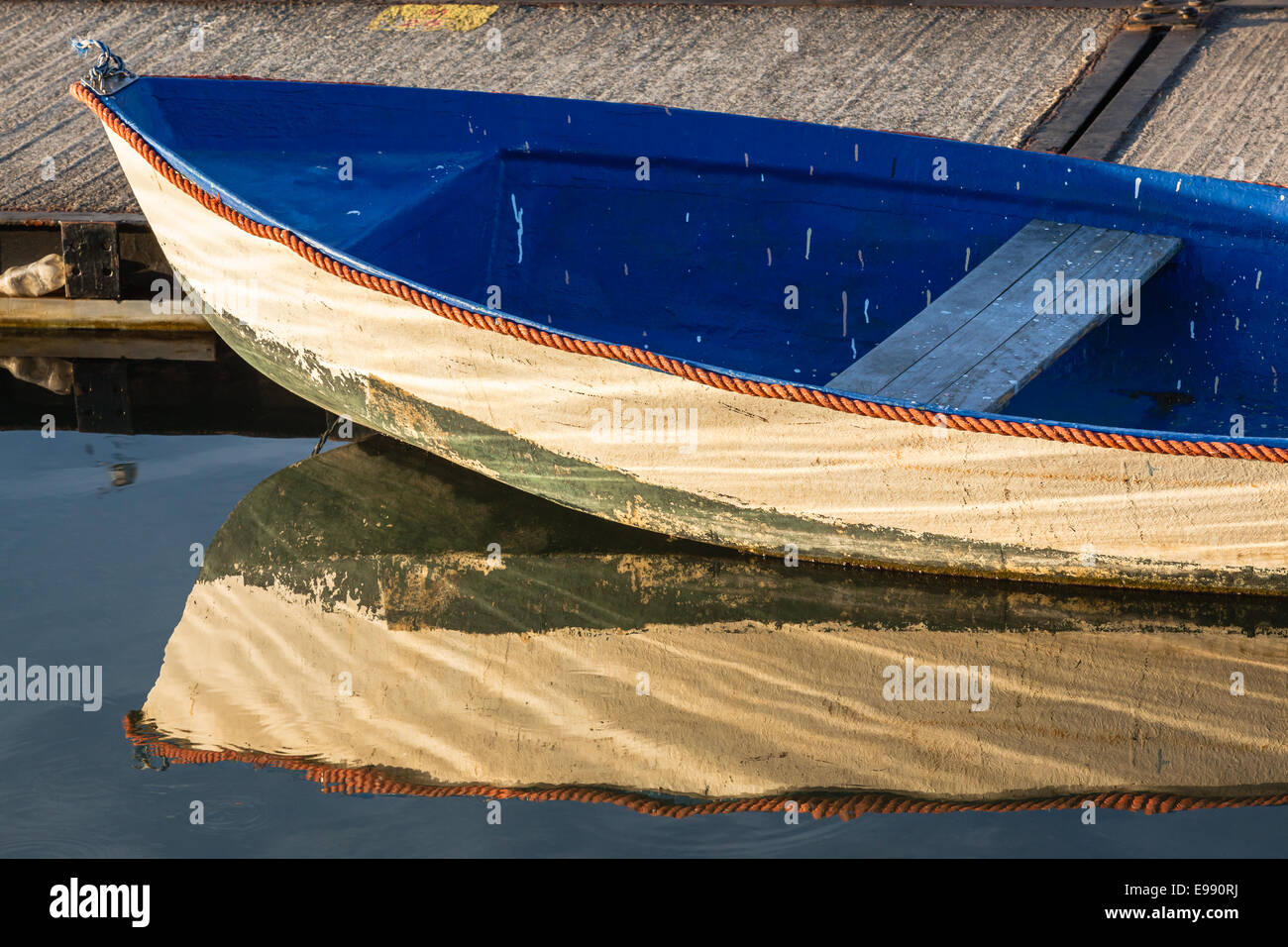 Small Boat mirror water reflections Stock Photo - Alamy
