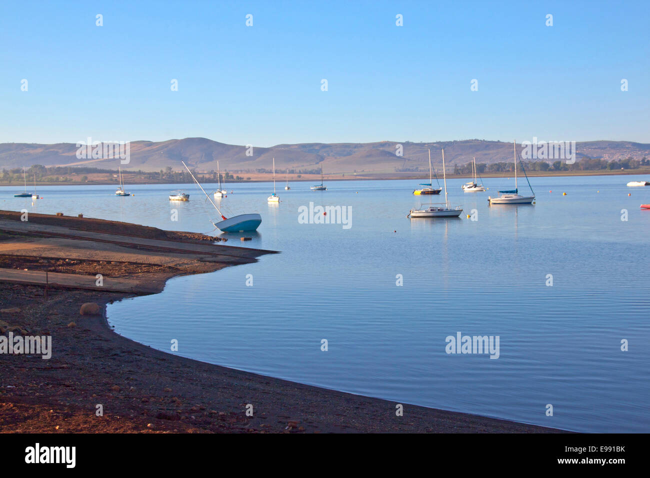 Early morning view of boat slipway on Midmar dam against Yachts ...
