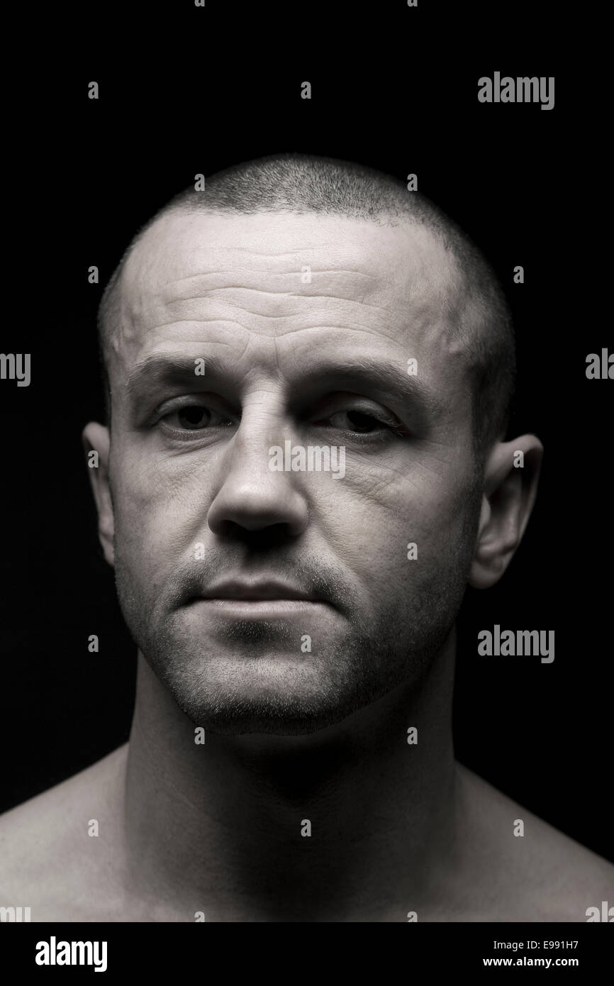 portrait shots of a tough looking street fighter man with tattoos shot ...