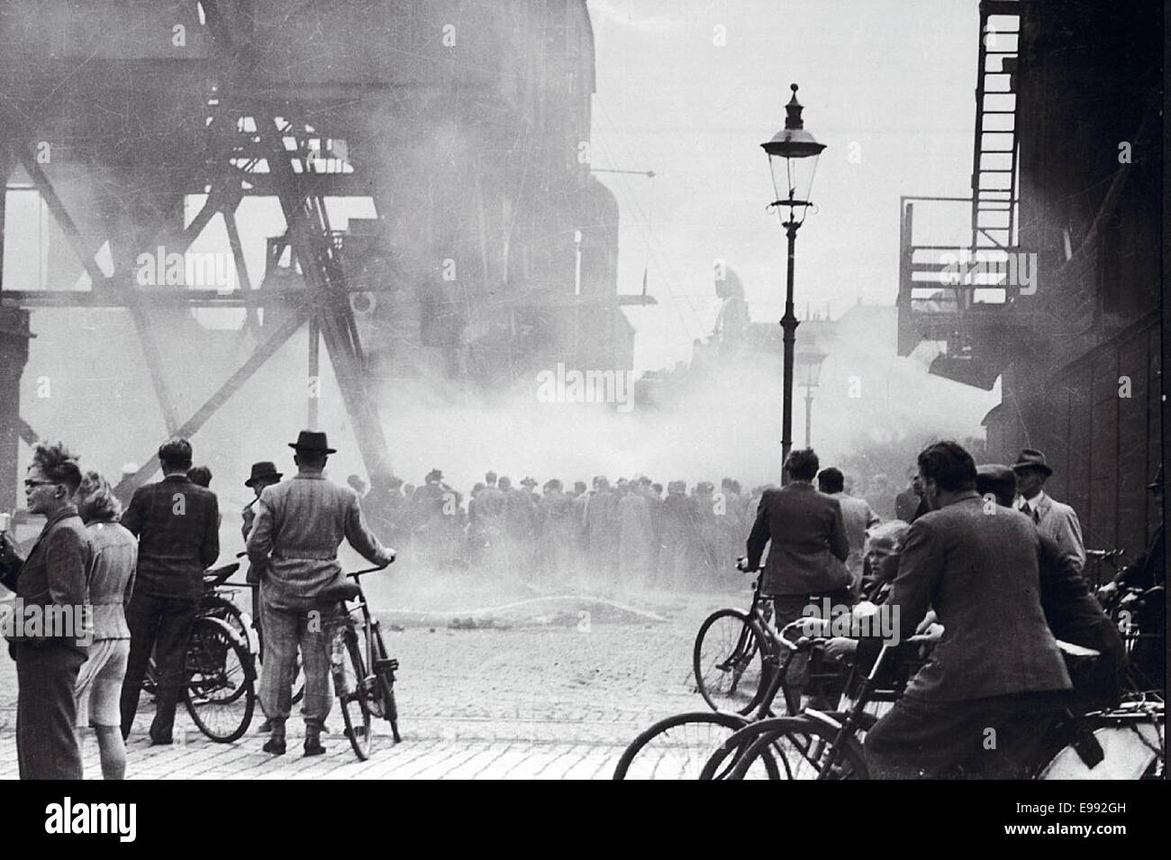 A photograph of people observing the aftermath of a sabotage event near ...