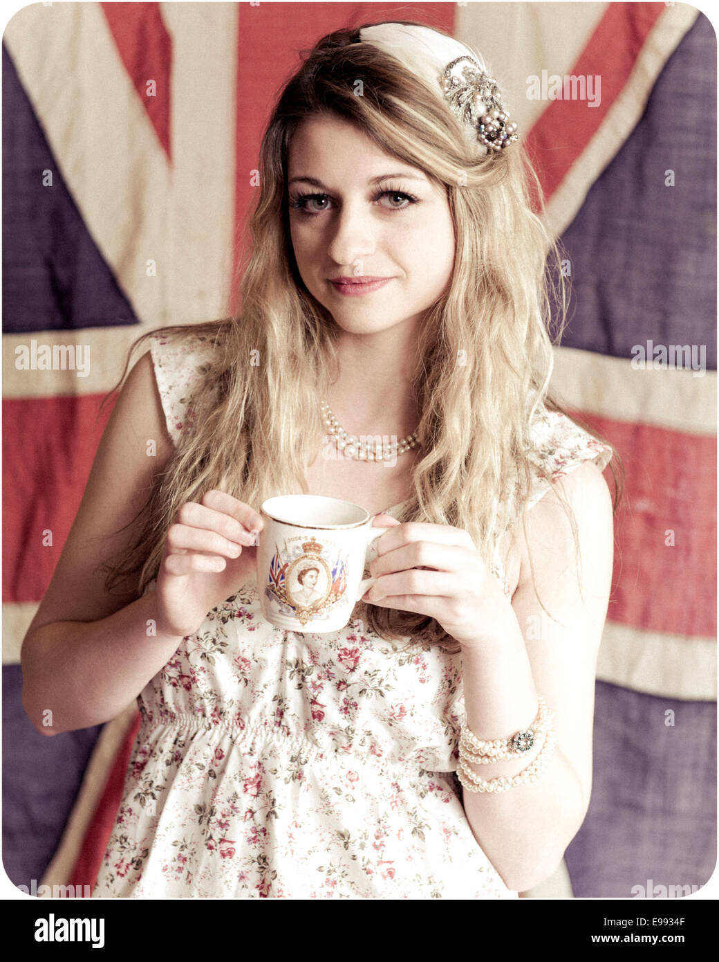 vintage looking photo of a young lady holding a coronation tea cup in ...