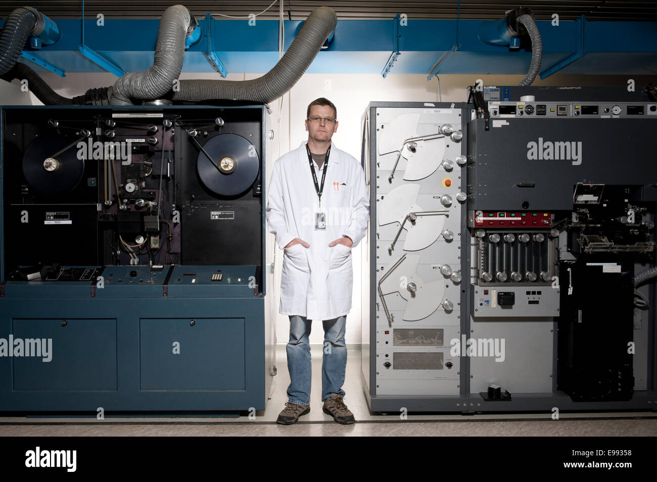 portrait of technical member of staff at the BFI archive with white lab ...