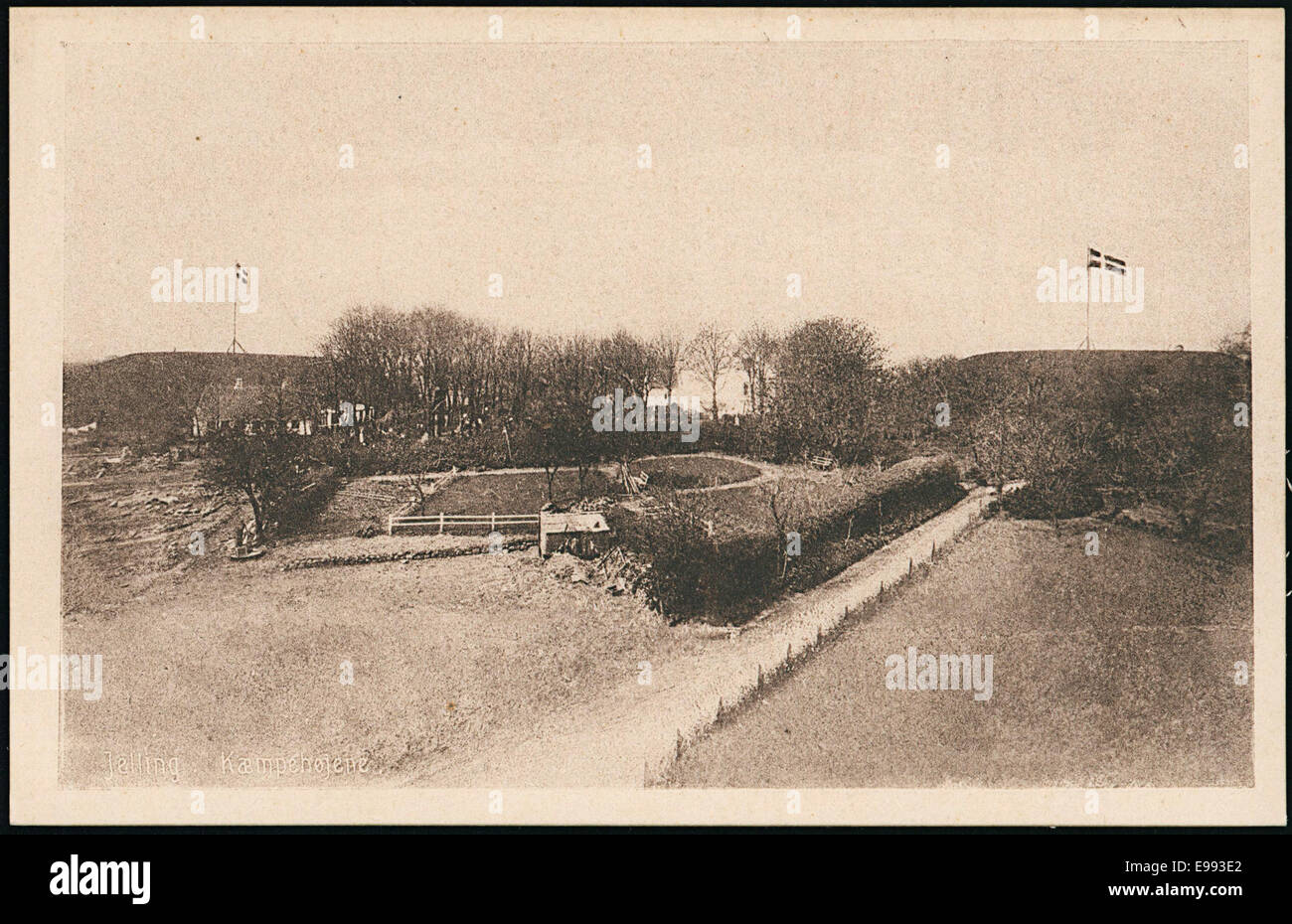 This image shows the two Viking burial mounds at Jelling, Denmark ...