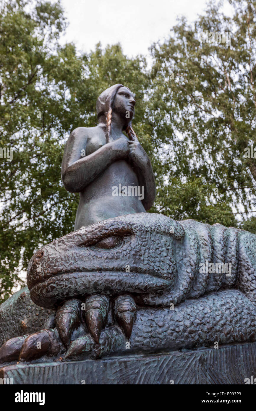 Statue on bronze represent a young woman and big lizard. Oslo ...