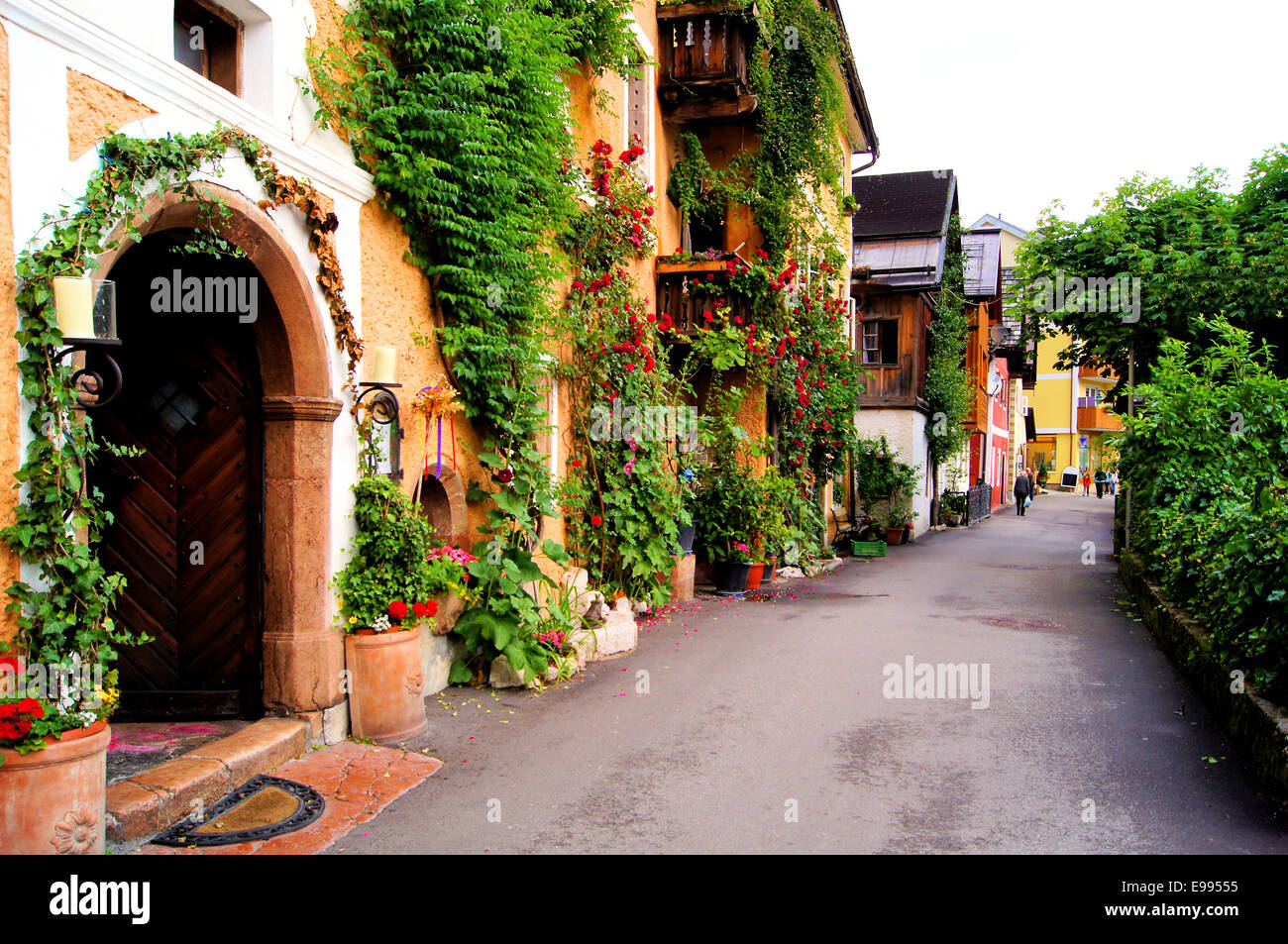 Flower lined street in the traditional Austrian village of Hallstatt ...