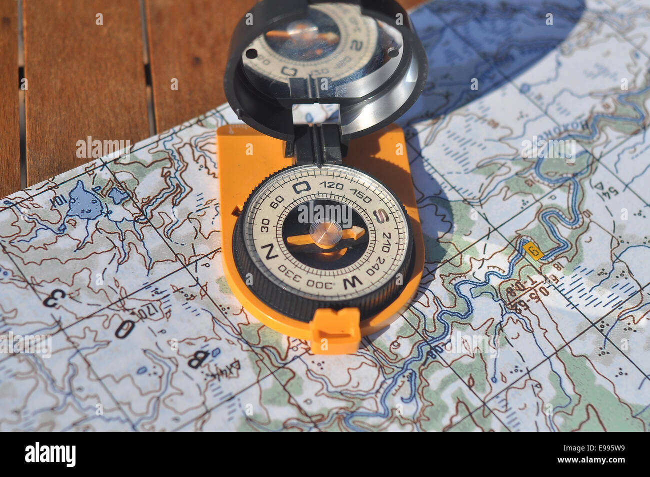 Compass, map. The magnetic compass is located on a topographic map ...