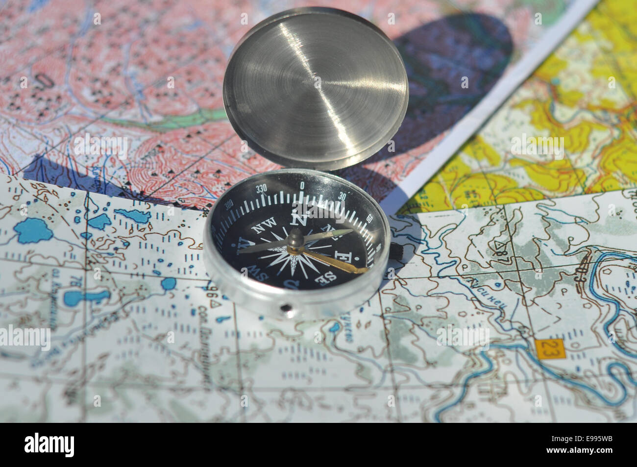 Compass, map. The magnetic compass is located on a topographic map ...
