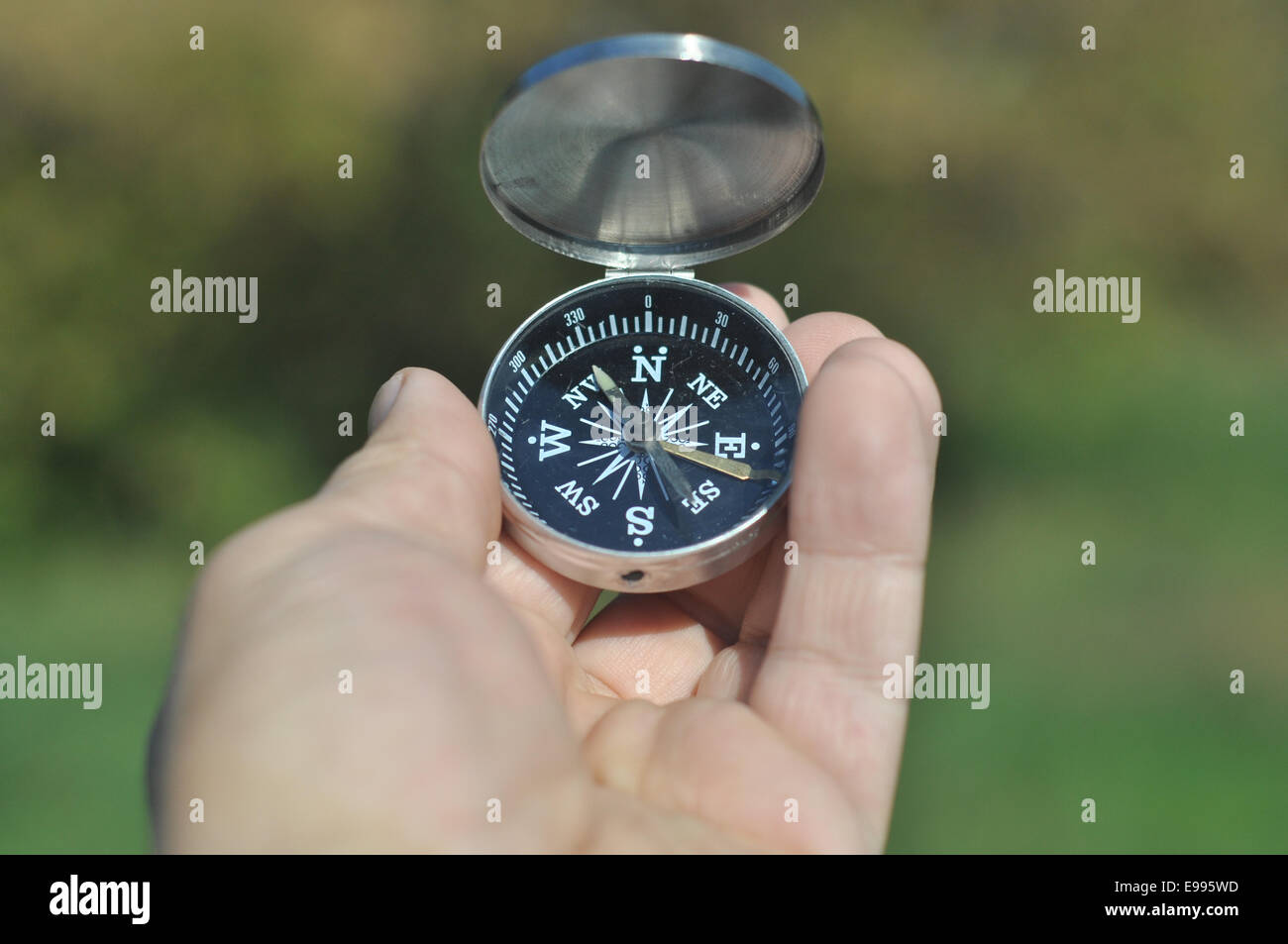 Compass in hand. Open the magnetic compass holds the left hand men ...