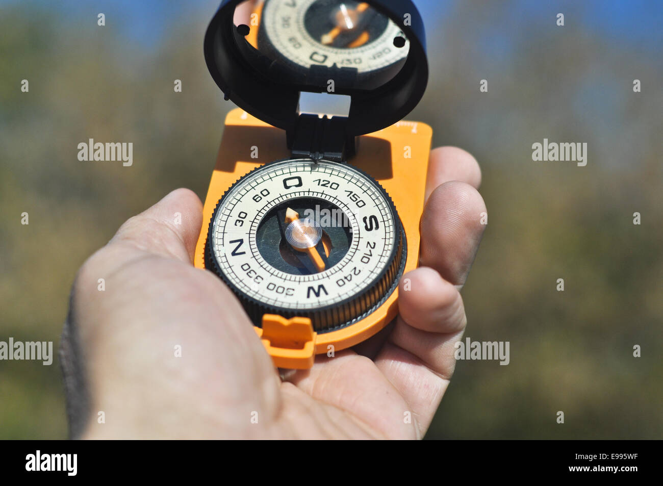 Compass in hand. Open the magnetic compass holds the left hand men ...