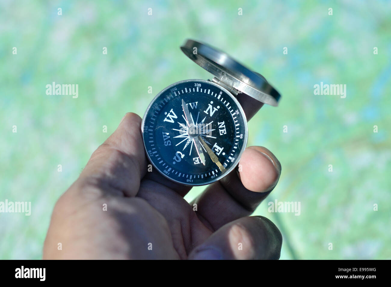 Compass in hand. Open the magnetic compass holds the left hand men ...
