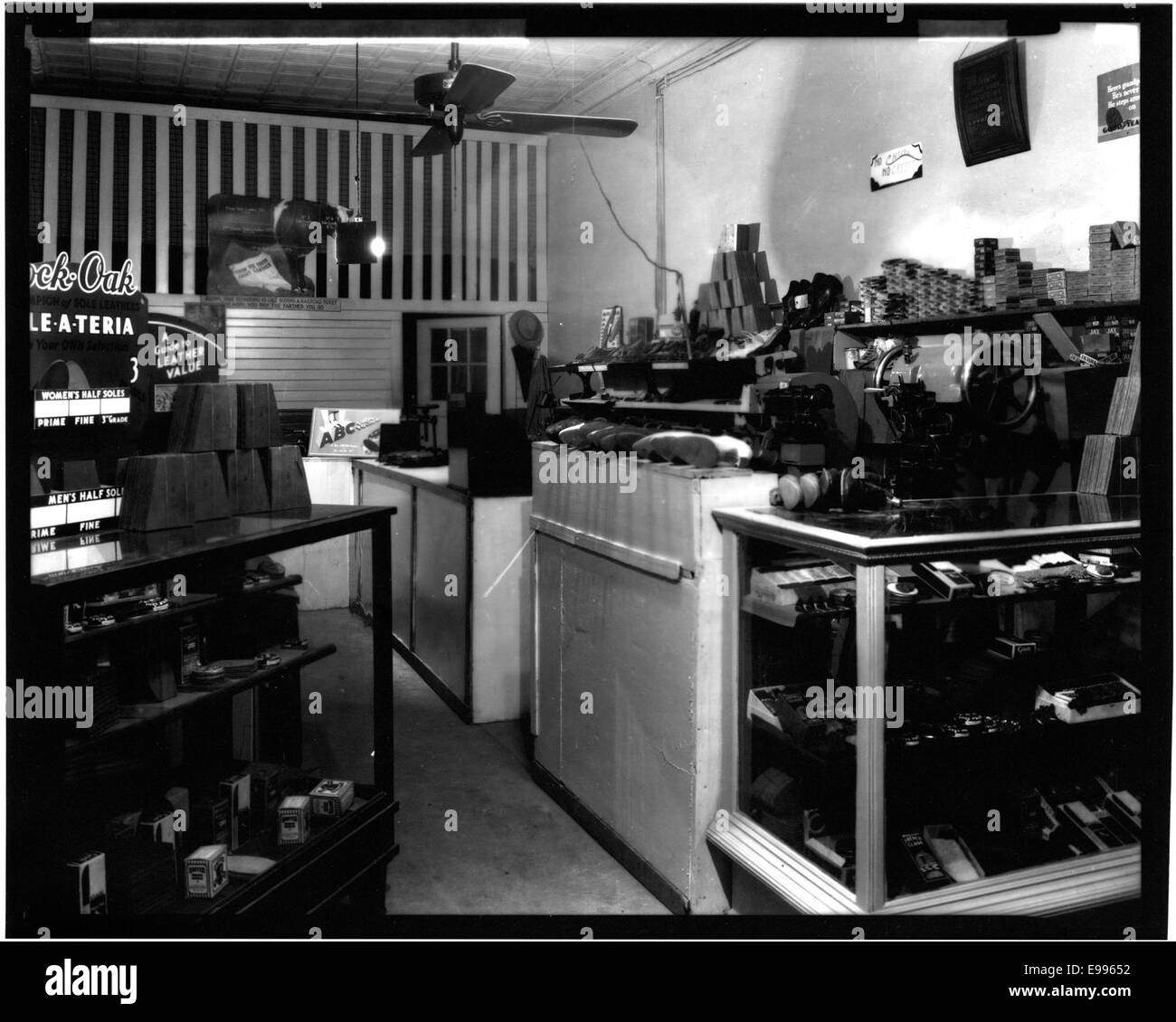 This photograph shows a traditional shoe repair shop, capturing the ...