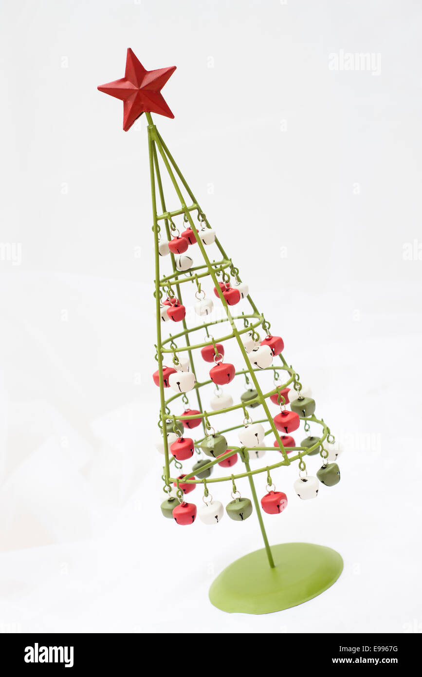 Contemporary metal Christmas tree with bells against a white background ...