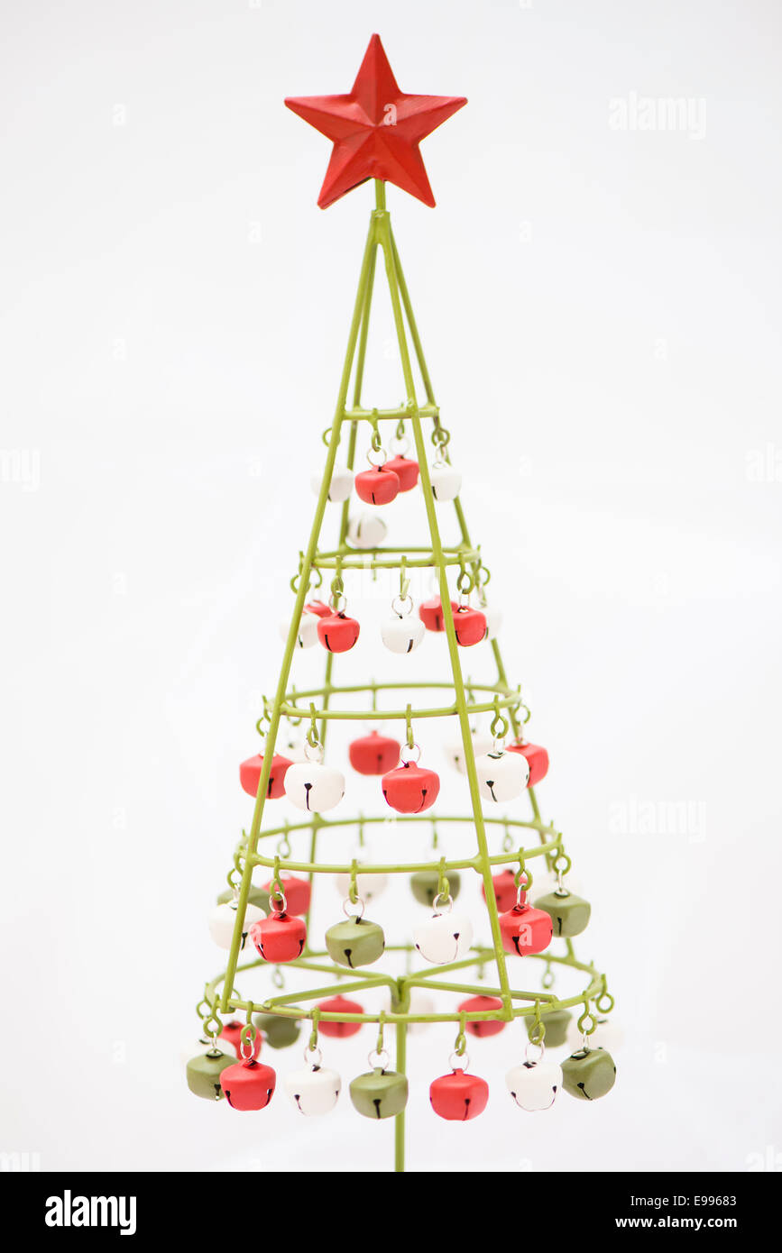 Contemporary metal Christmas tree with bells against a white background ...
