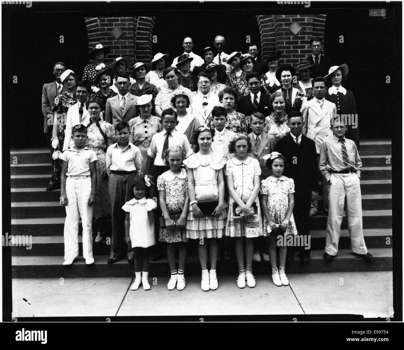 A photograph showing unidentified men, women, and children, likely from ...