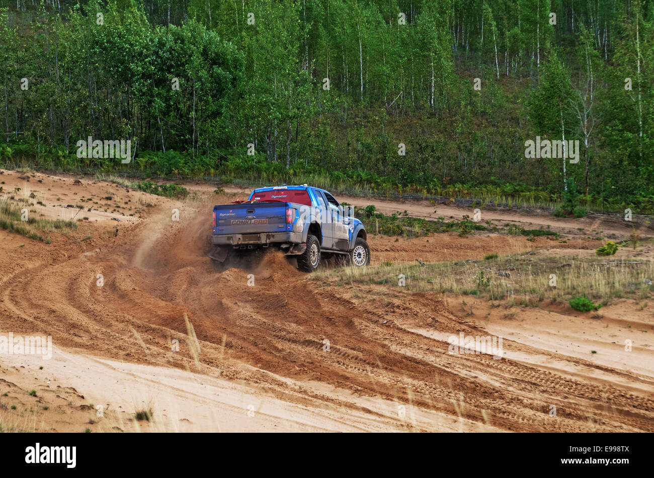 Races on a rally-raid on sandy dunes. Racing car number 207 Stock Photo ...
