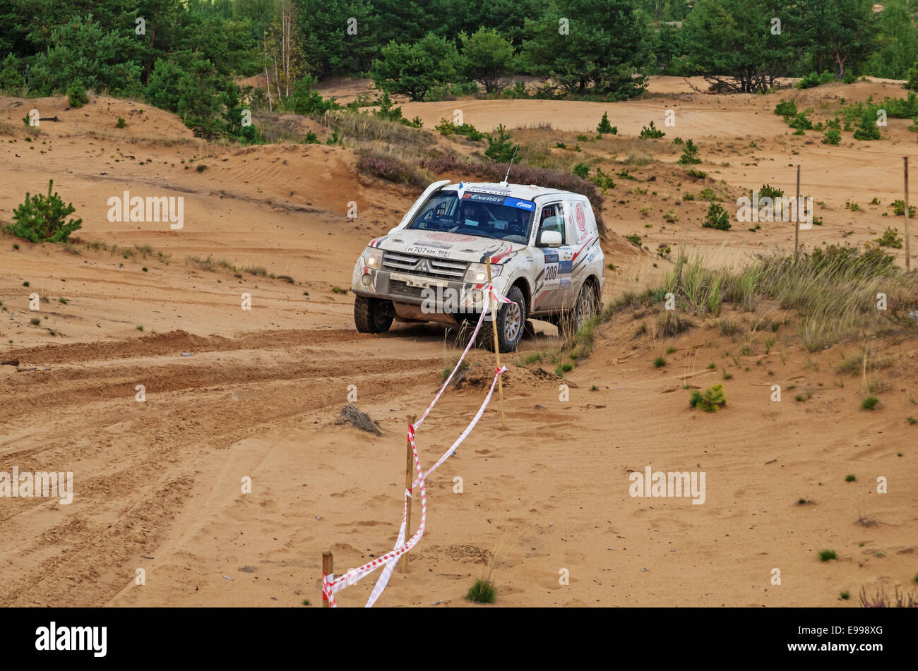Races on a rally-raid on sandy dunes. Racing car number 208 Stock Photo ...