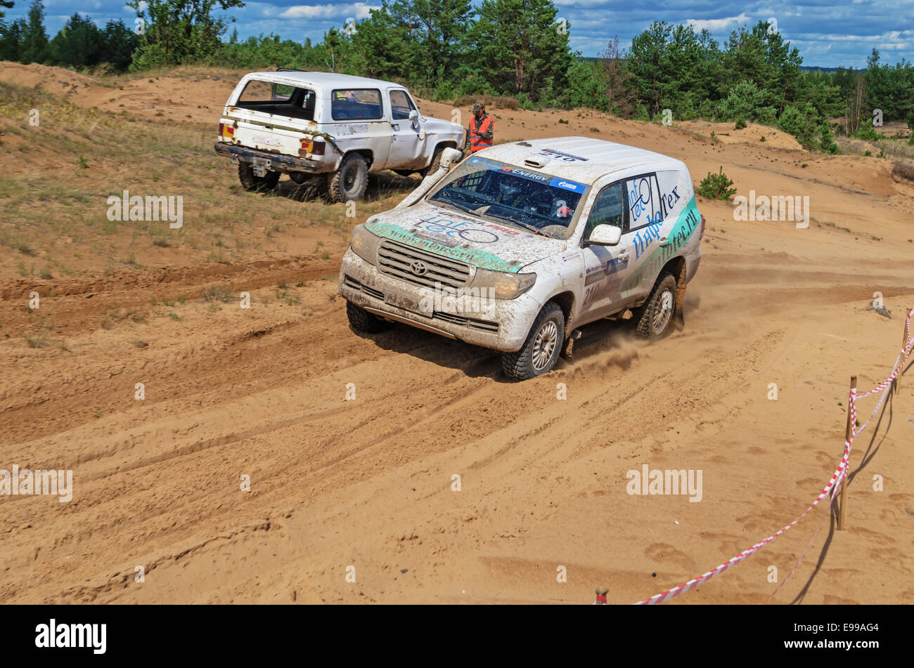 Races on a rally-raid on sandy dunes. Racing car number 210 Stock Photo ...