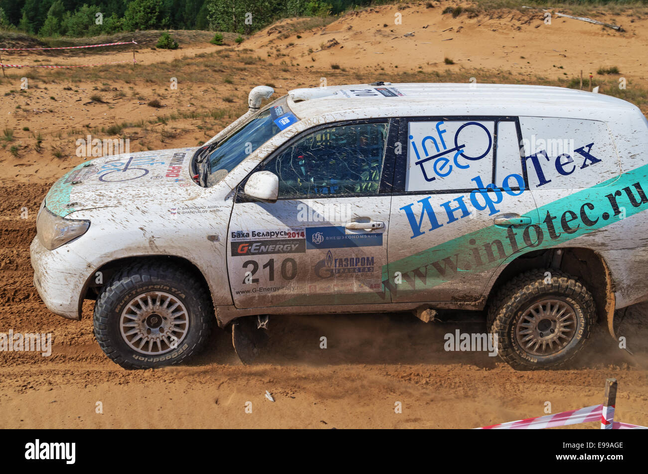 Races on a rally-raid on sandy dunes. Racing car number 210 Stock Photo ...