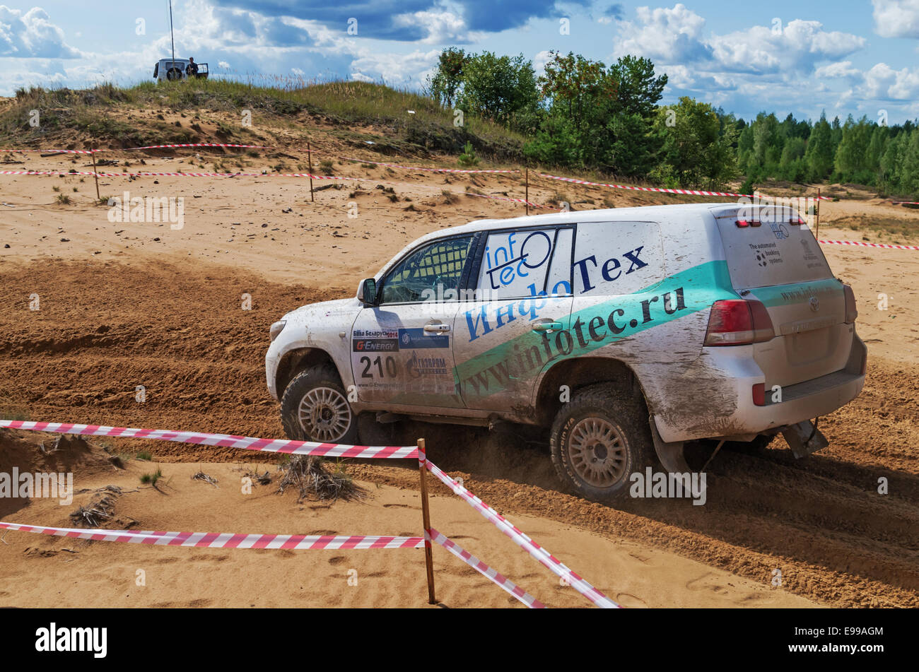 Races on a rally-raid on sandy dunes. Racing car number 210 Stock Photo ...