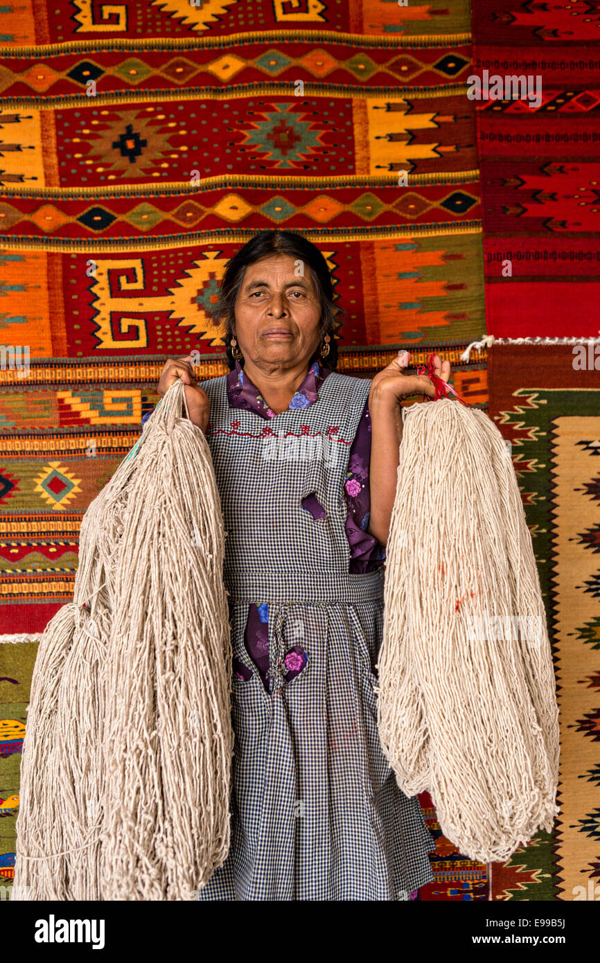 A Zapotec indigenous woman holds natural yarn after spinning it for use ...