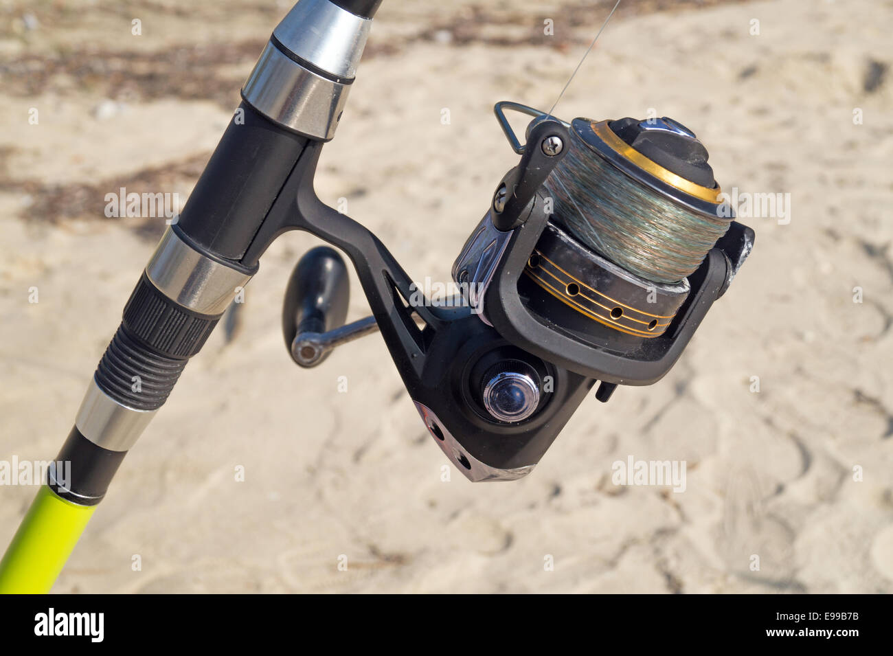 Fishing rod and reel on the beach Stock Photo - Alamy