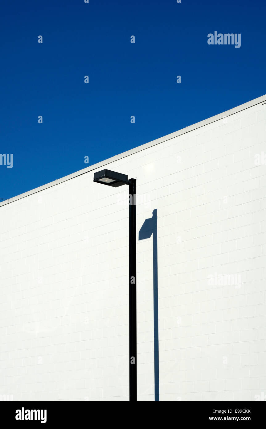 Black lamppost against a stark white wall, lamp post shadow Stock Photo ...