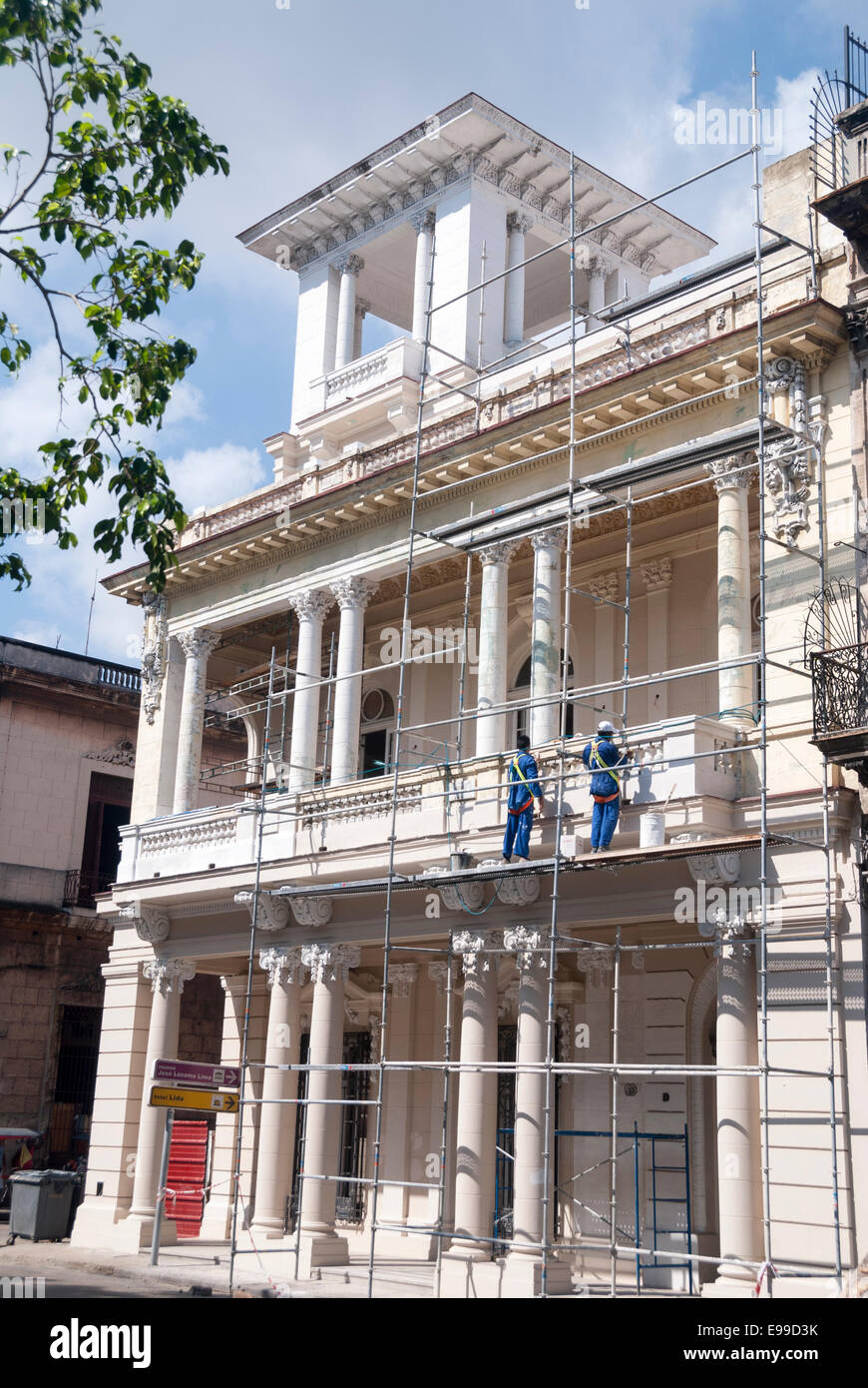 Workmen in the midst of restoring one of the many historic Spanish ...