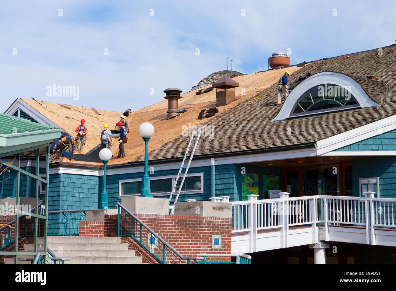 Construction workers working on rooftop of building - USA Stock Photo ...