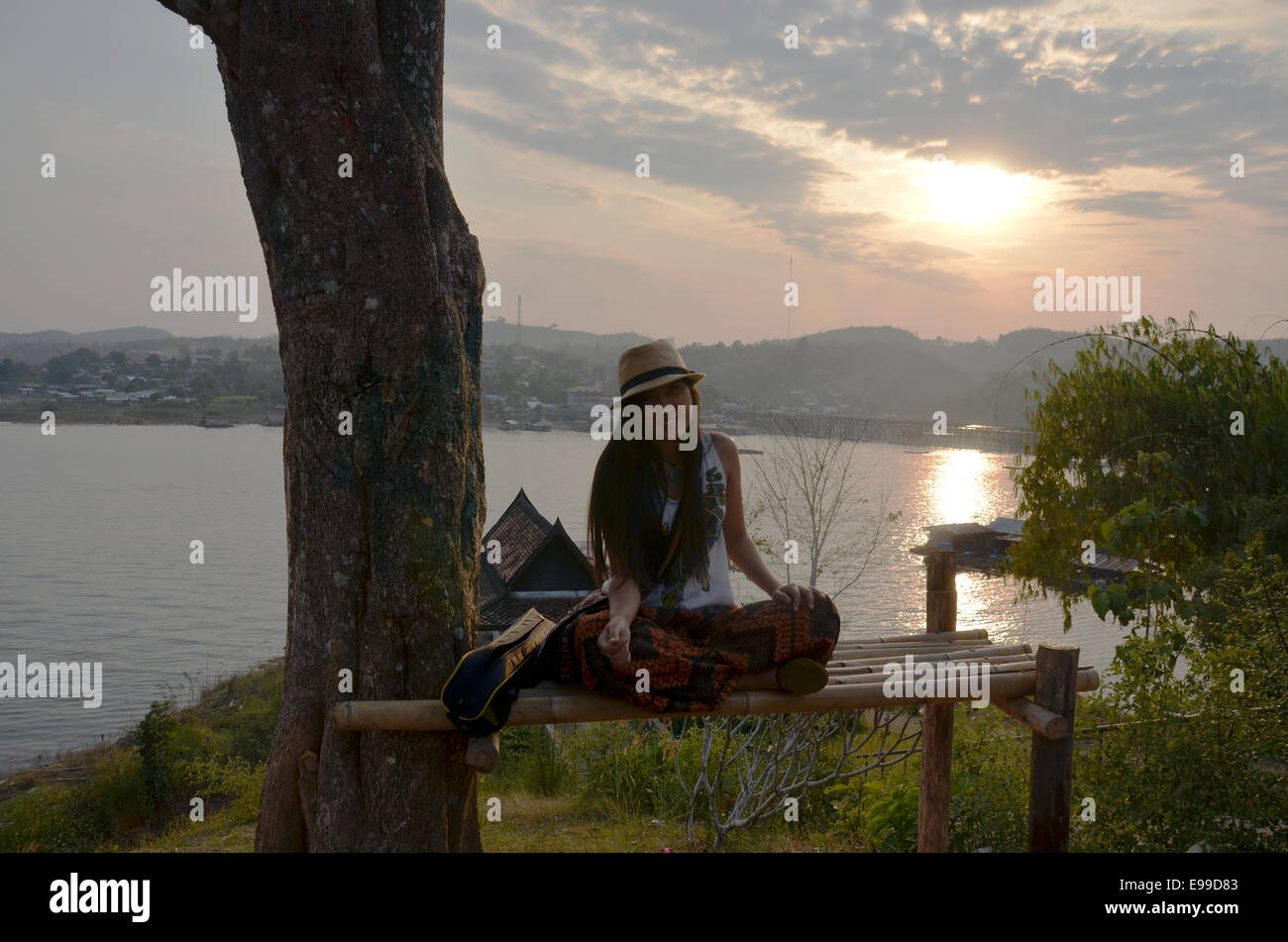 Thai women sitting near Saphan Mon - The 400m wooden bridge itself is ...