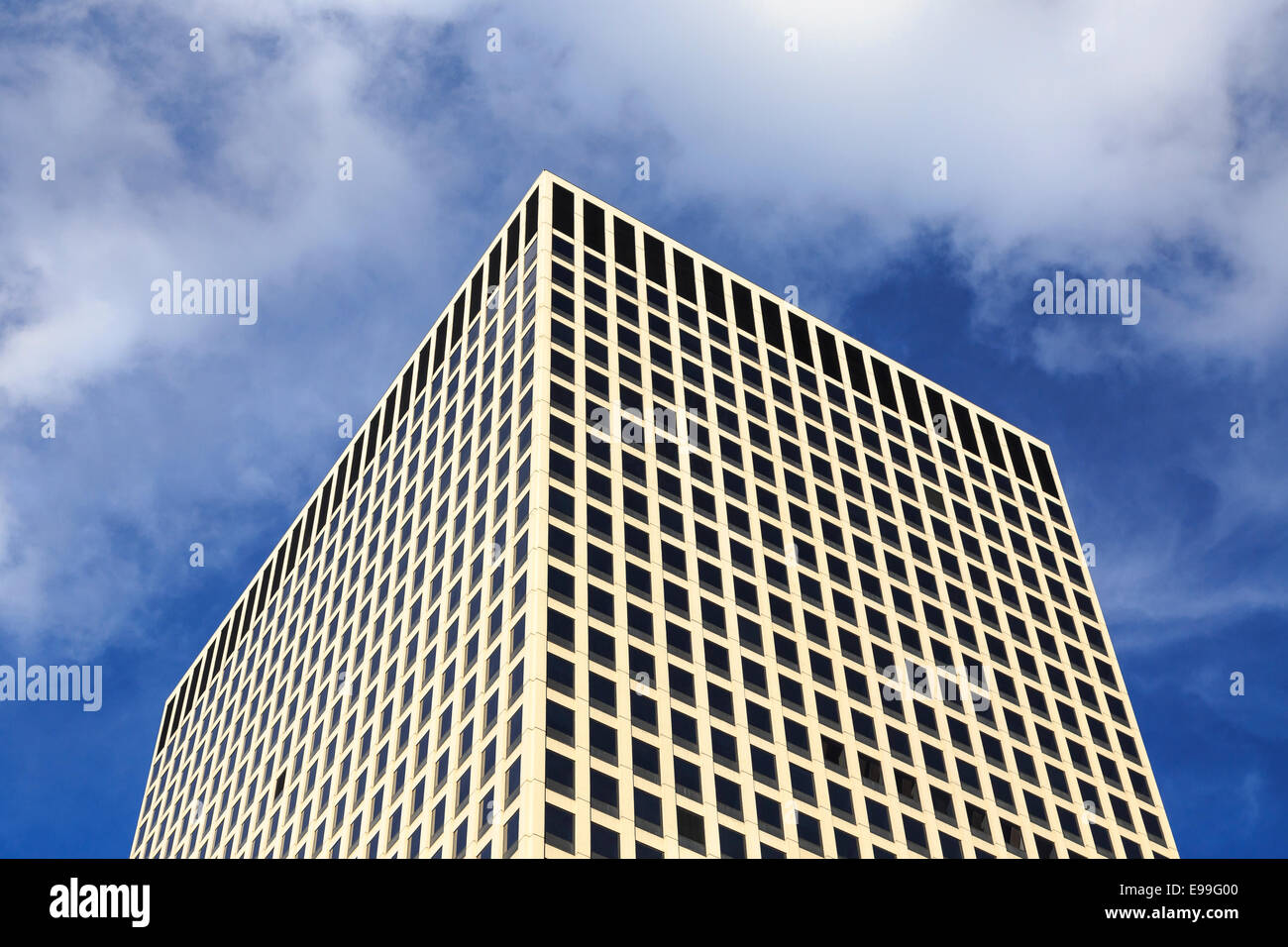 Monolithic bright skyscraper rises before the camera Stock Photo - Alamy