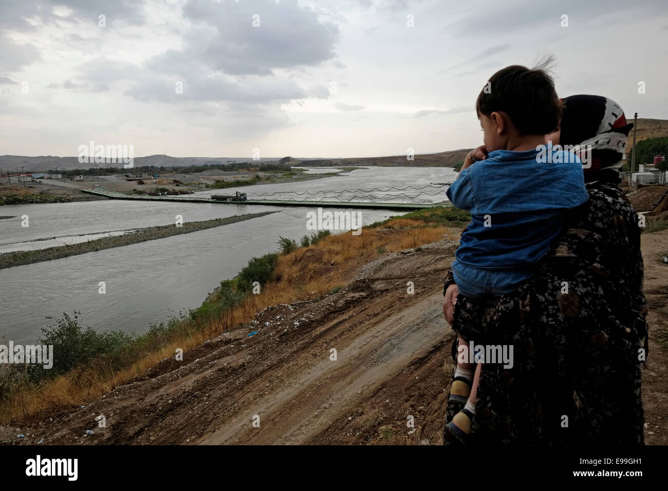 A Kurdish mother and her child gazing from the Syrian side of Faysh ...