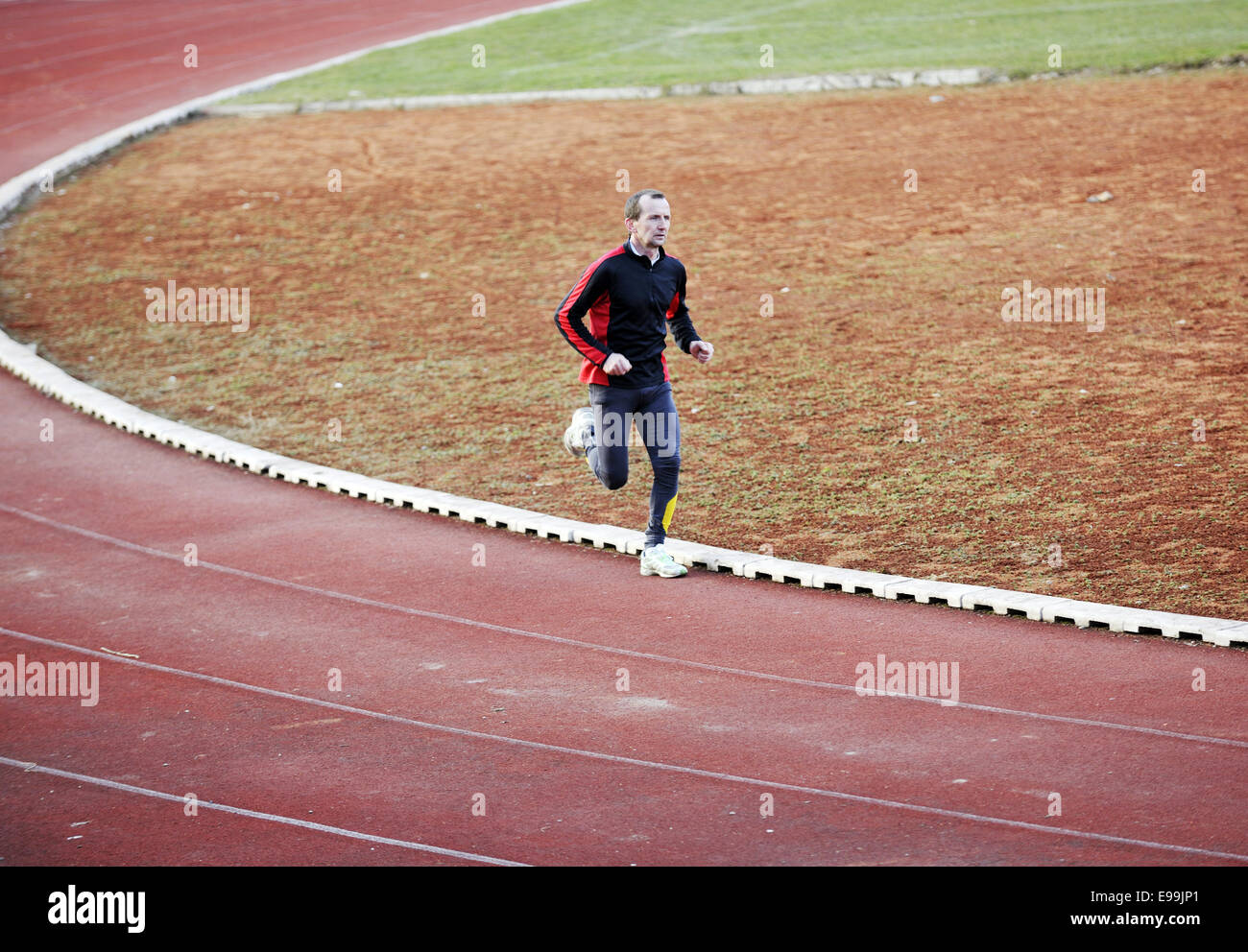 adult man running on athletics track Stock Photo - Alamy