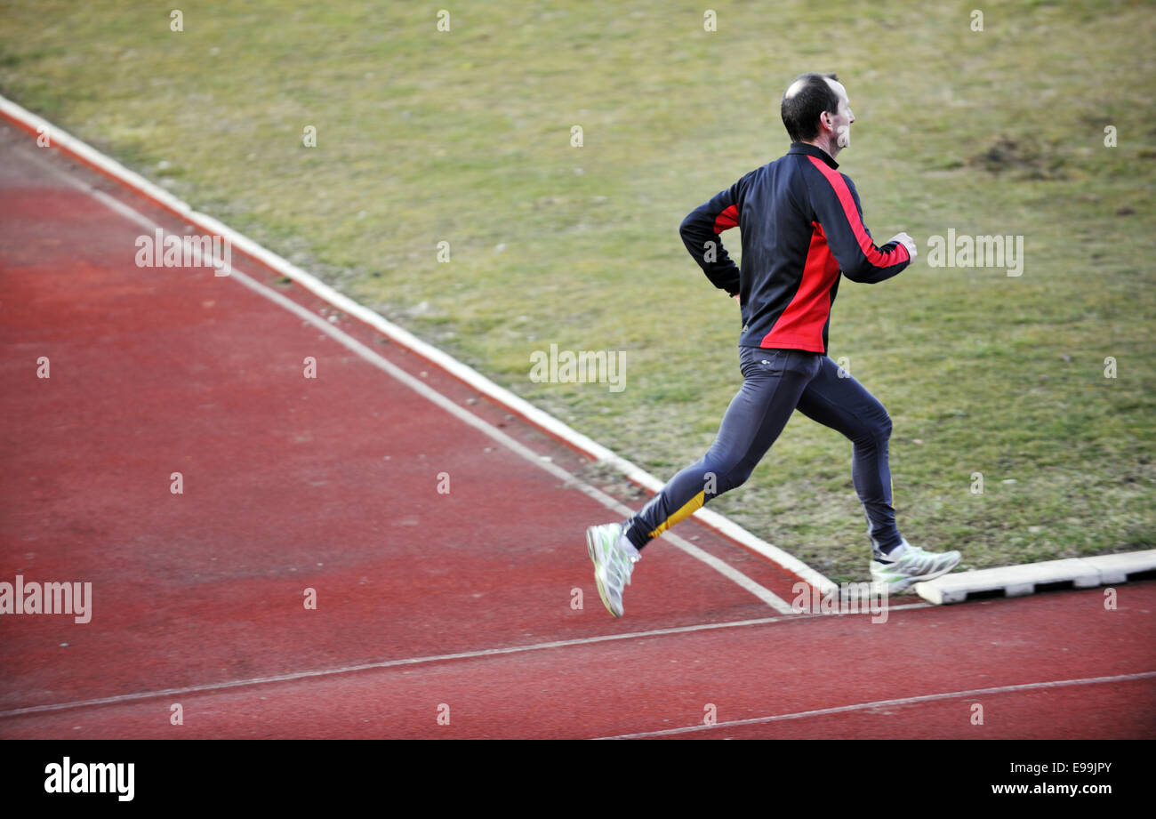 adult man running on athletics track Stock Photo - Alamy