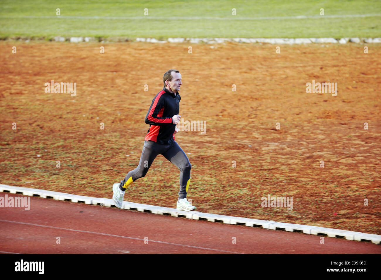 adult man running on athletics track Stock Photo - Alamy