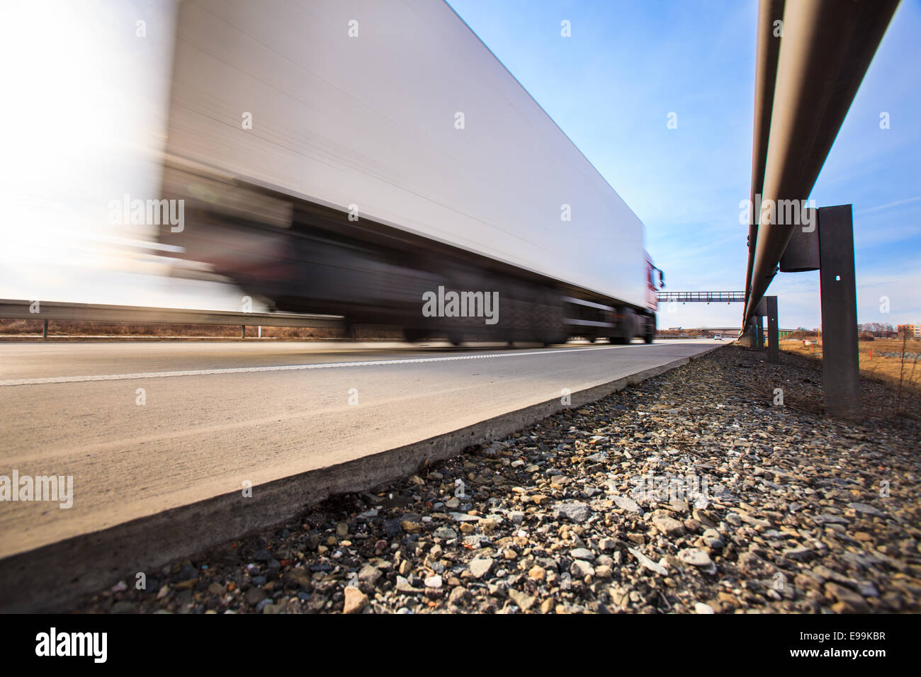 Truck passing through a toll gate on a highway (motion blurred image ...