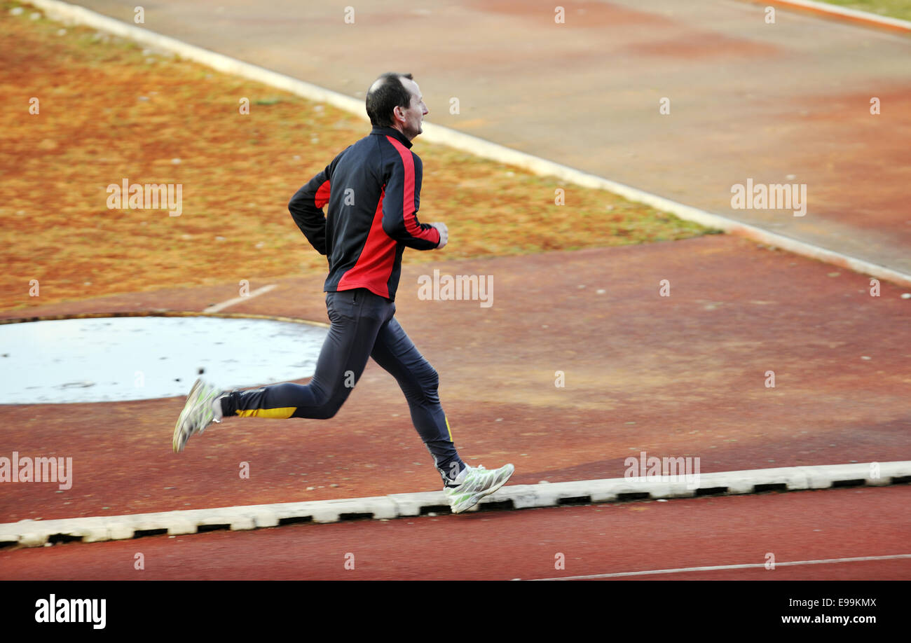 adult man running on athletics track Stock Photo - Alamy