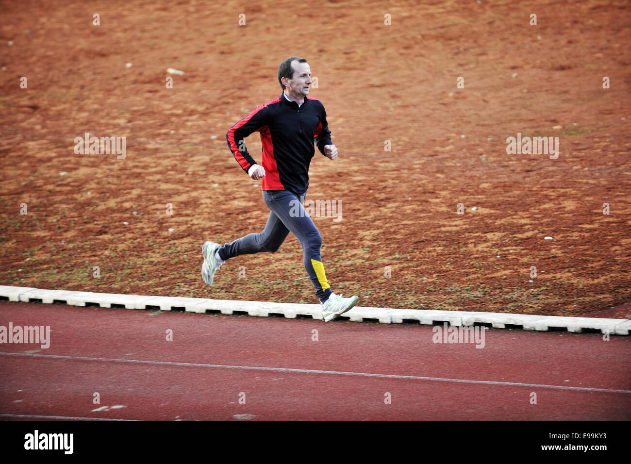 adult man running on athletics track Stock Photo - Alamy